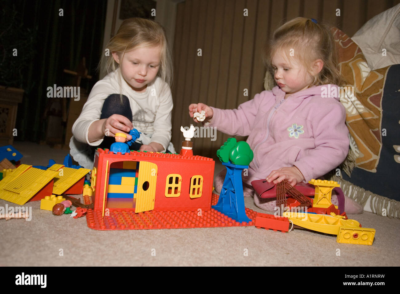Two young girls playing with Duplo building blocks UK Stock Photo - Alamy
