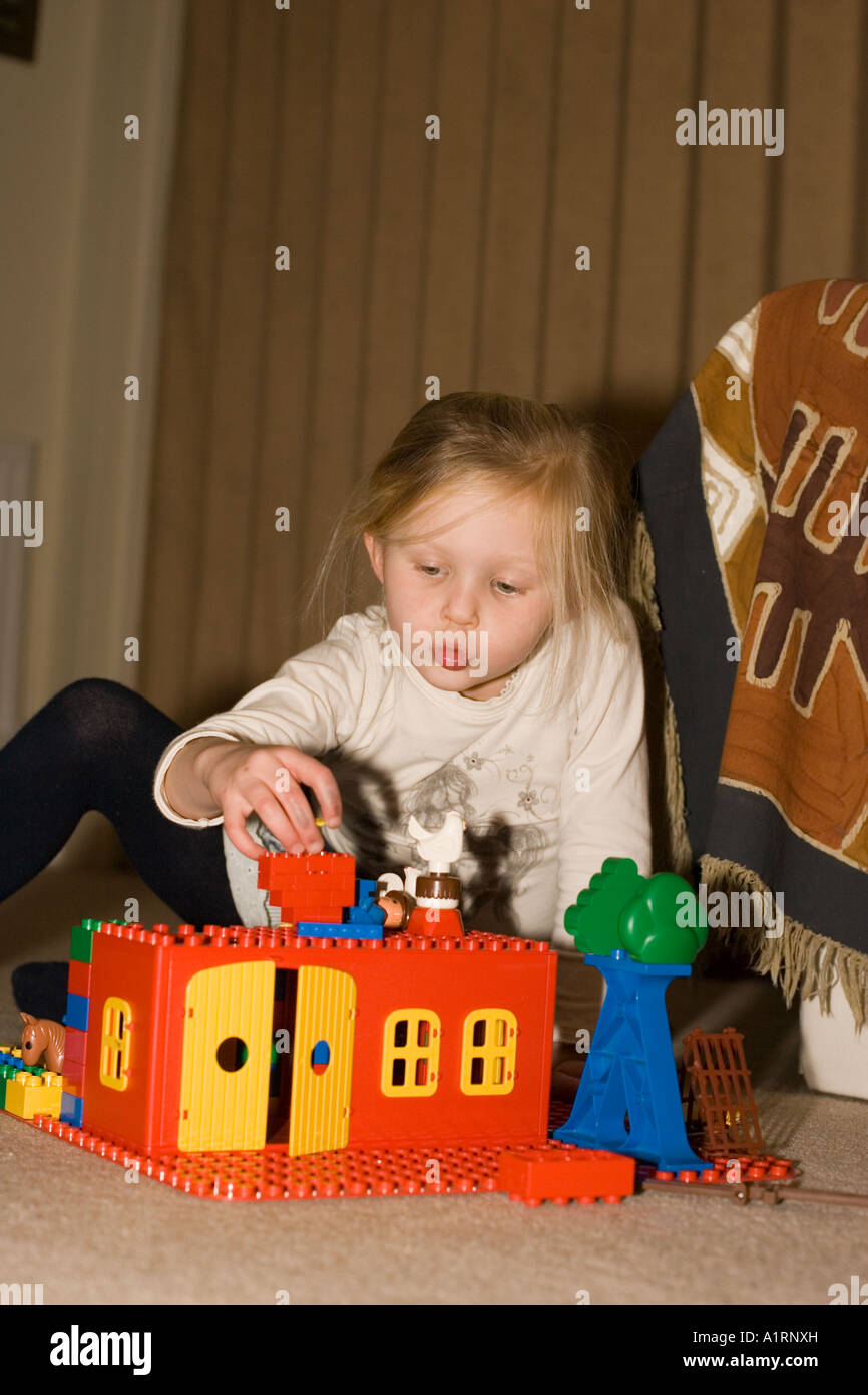 Four year old girl playing with Duplo building blocks UK Stock Photo ...
