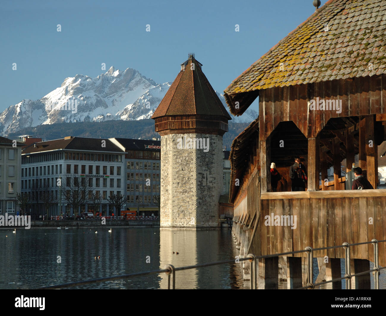 chapel bridge and water tower early morning with mount pilatus in the ...
