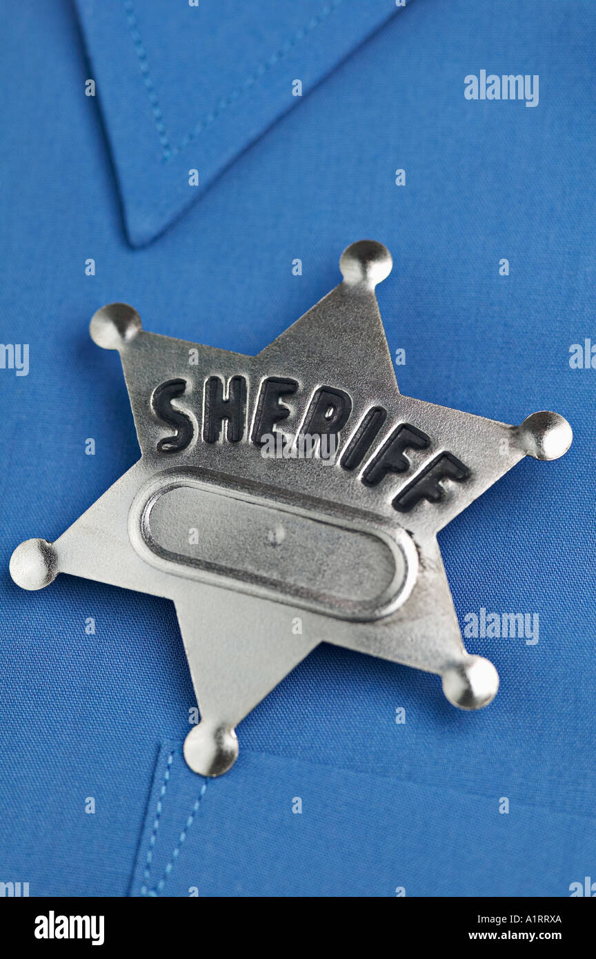 Sheriff badge on blue shirt Stock Photo - Alamy