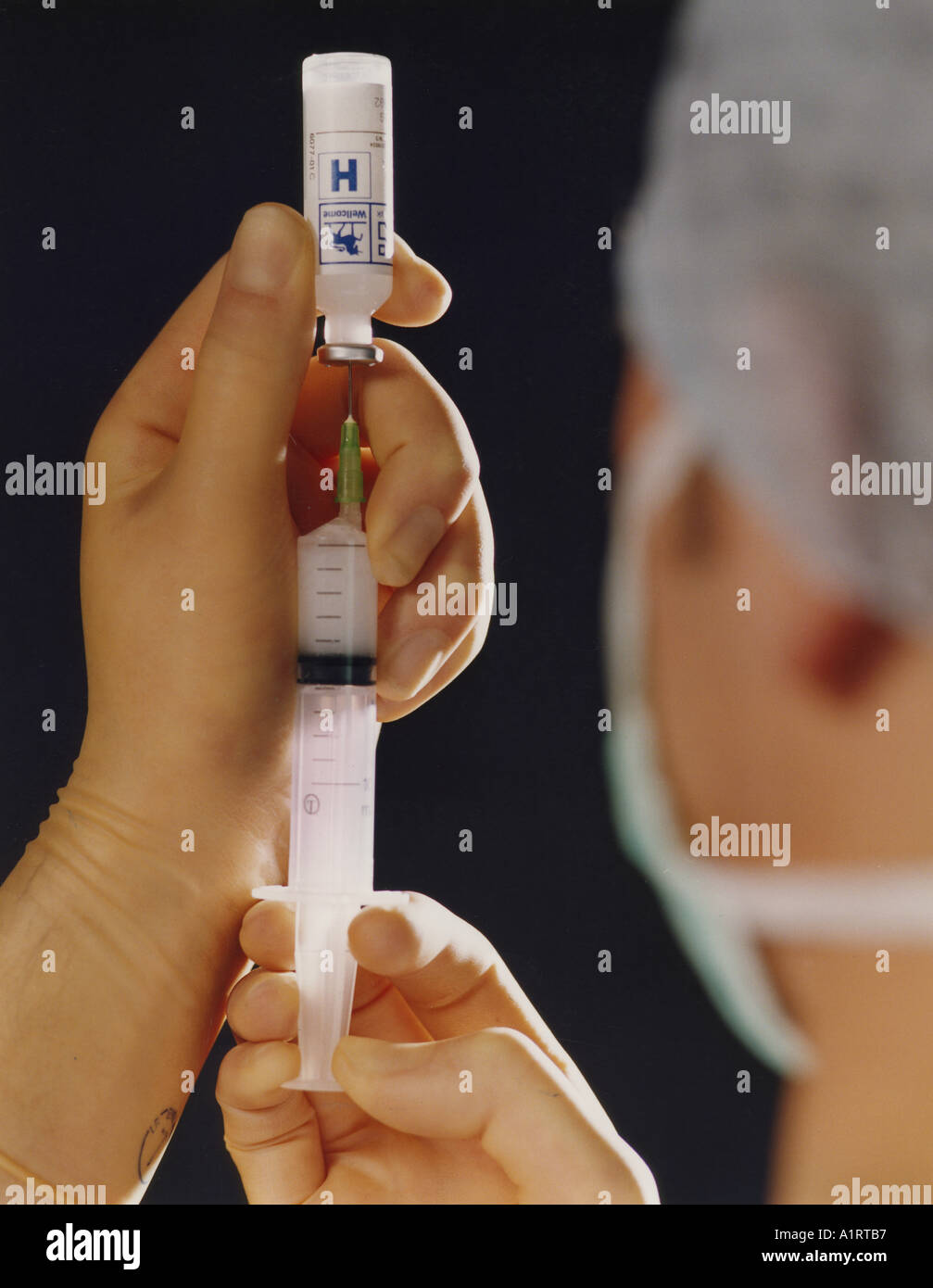 A MALE NURSE FILLS A HYPODERMIC NEEDLE Stock Photo - Alamy