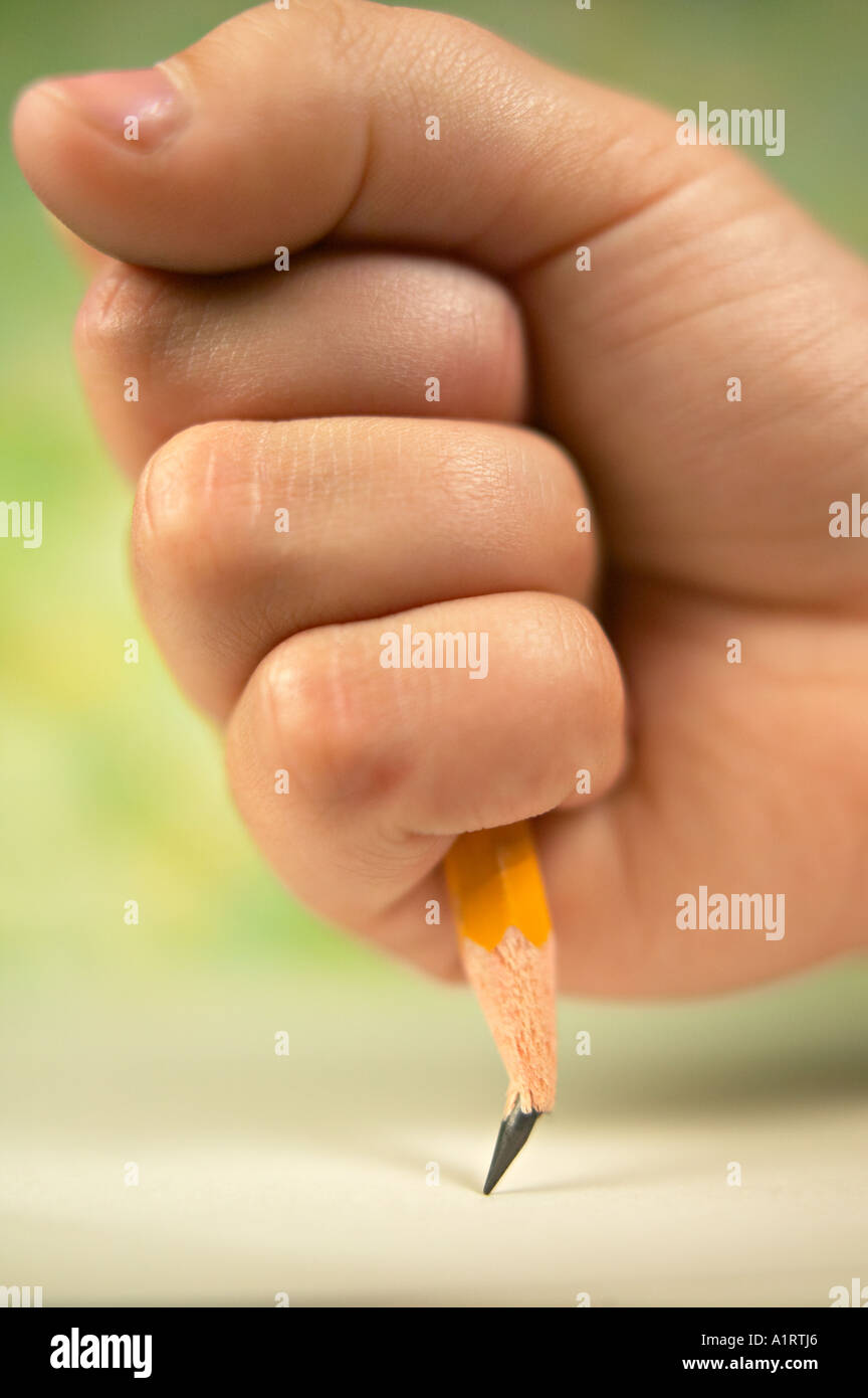 Fist breaking pencil Stock Photo - Alamy