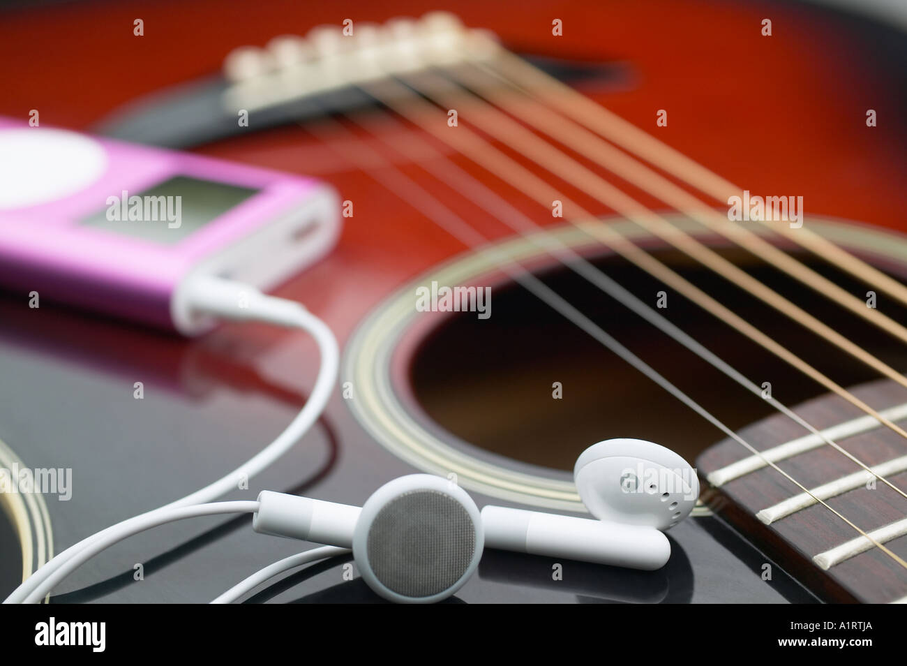 Guitar and mp3 music player Stock Photo - Alamy