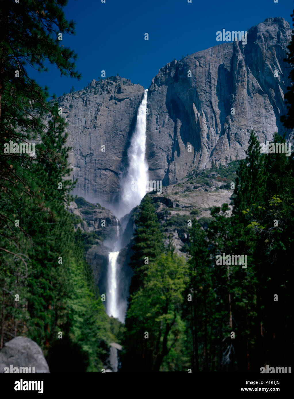Twin waterfalls cascade over granite cliffs in Yosemite National Park ...