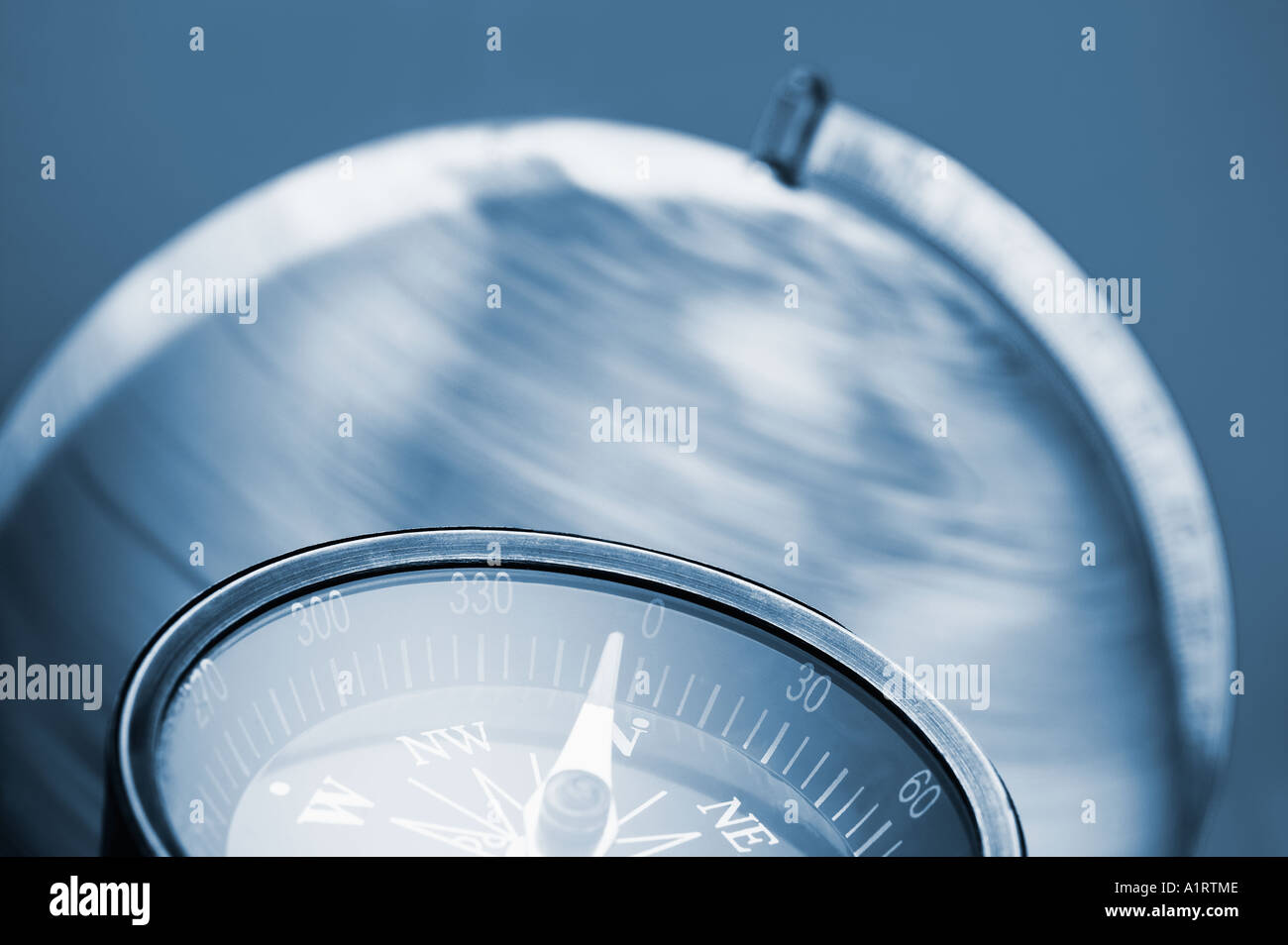 Spinning globe and compass Stock Photo - Alamy