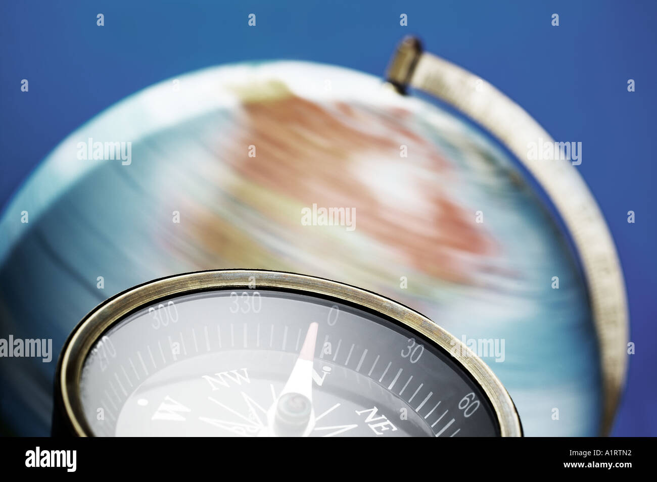 Spinning globe and compass Stock Photo - Alamy