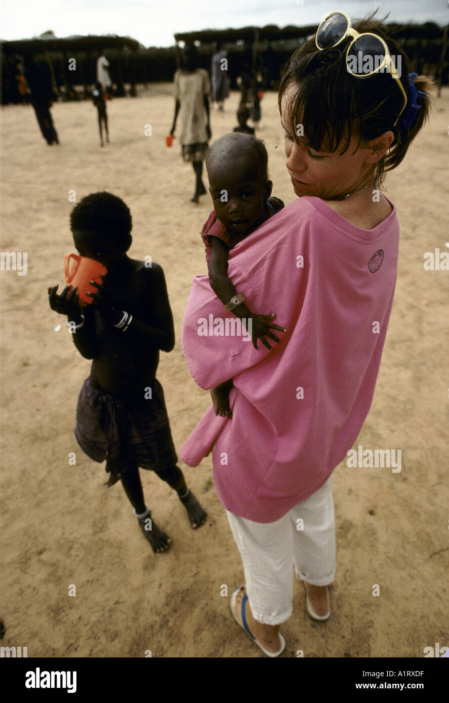 CONCERN WORKER HELPS CHILD AL MUGLAD FAMINE CAMP SUDAN 1988 Stock Photo ...