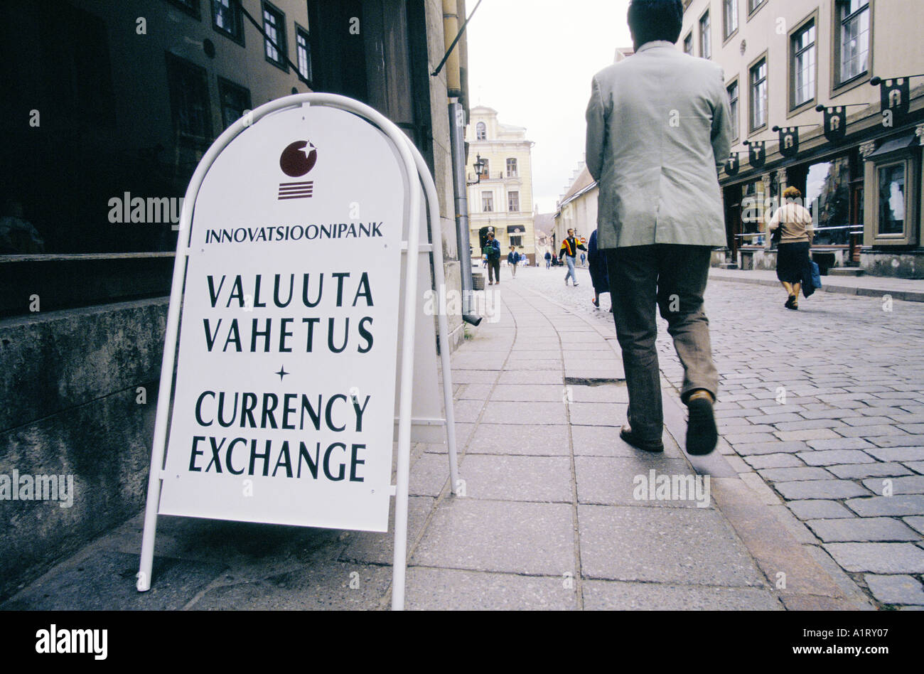 PEOPLE WALKING PAST SIGN FOR CURRENCY EXCHANGE STREET SCENE TALLINN ...