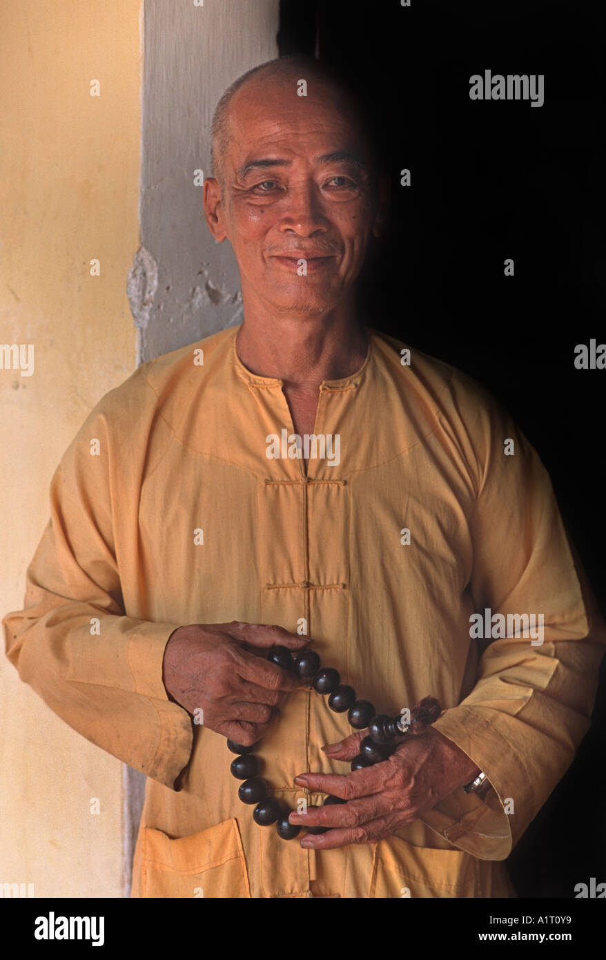 Abbot of a Vietnamese monastery in Saigon standing in a doorway and ...