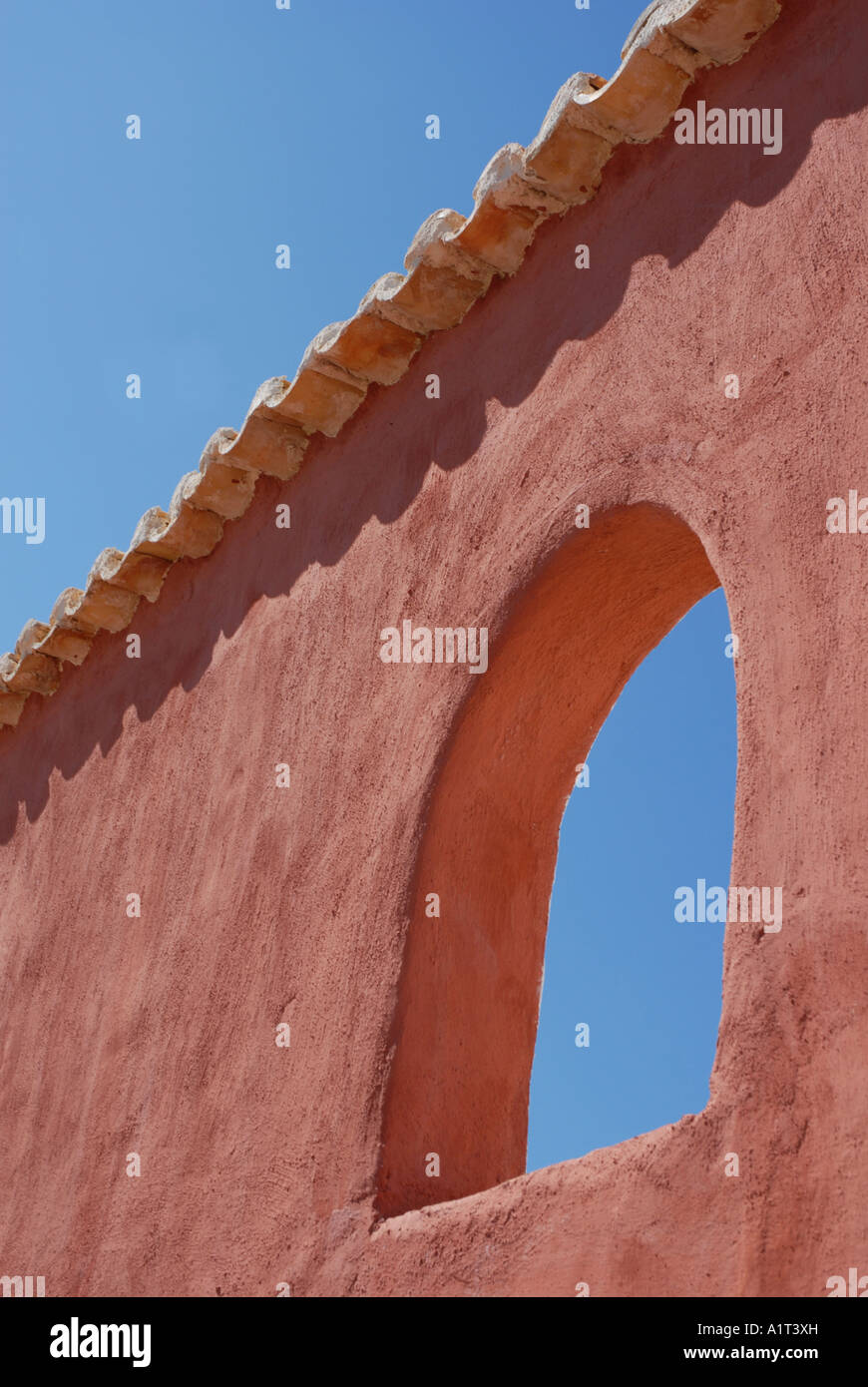 Mediterranean Greek terracotta exterior wall with open arched window ...