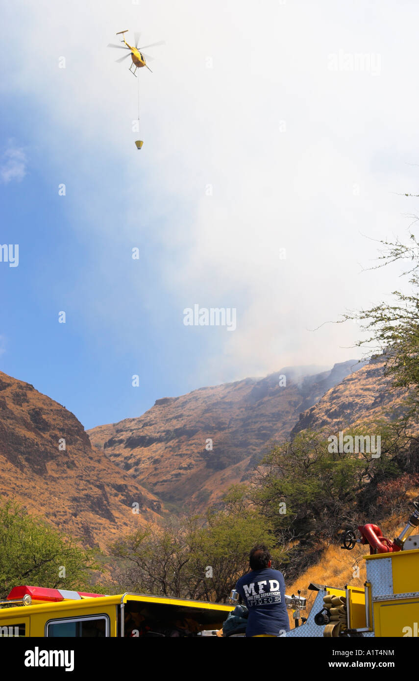 A firefighter looking at the fire helicopter during wildfires on Sept 1 ...