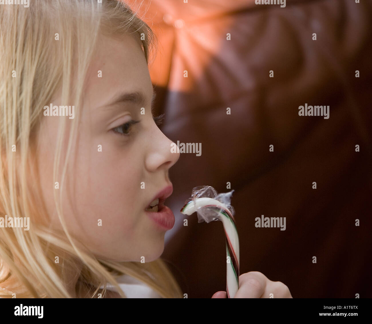 Child eating a candy cane Stock Photo - Alamy