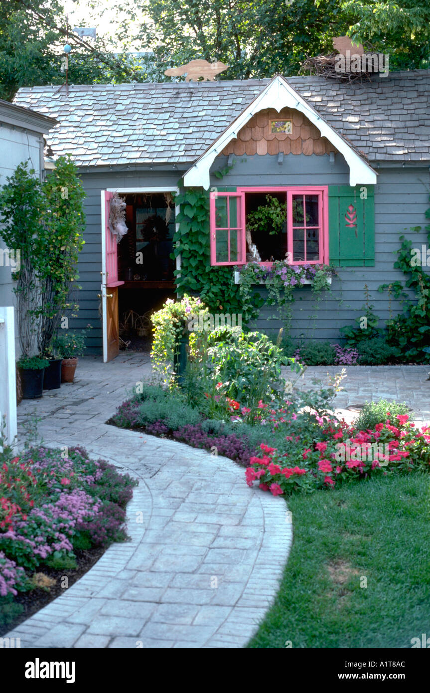 Decorative curved sidewalk lined with flowers to store. Minnetonka ...