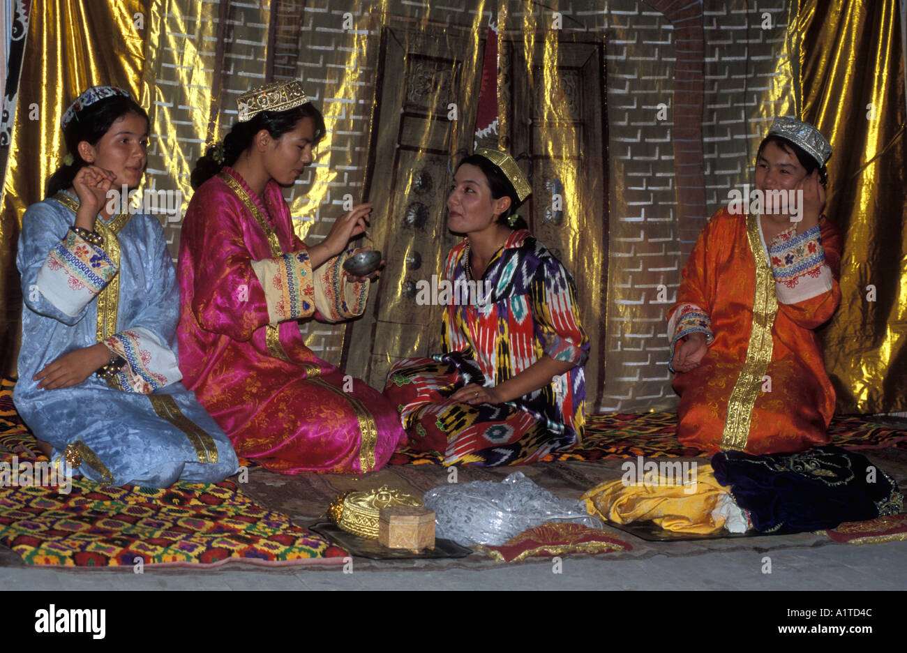 Young Uzbek women putting on a performance of traditional Uzbek family ...
