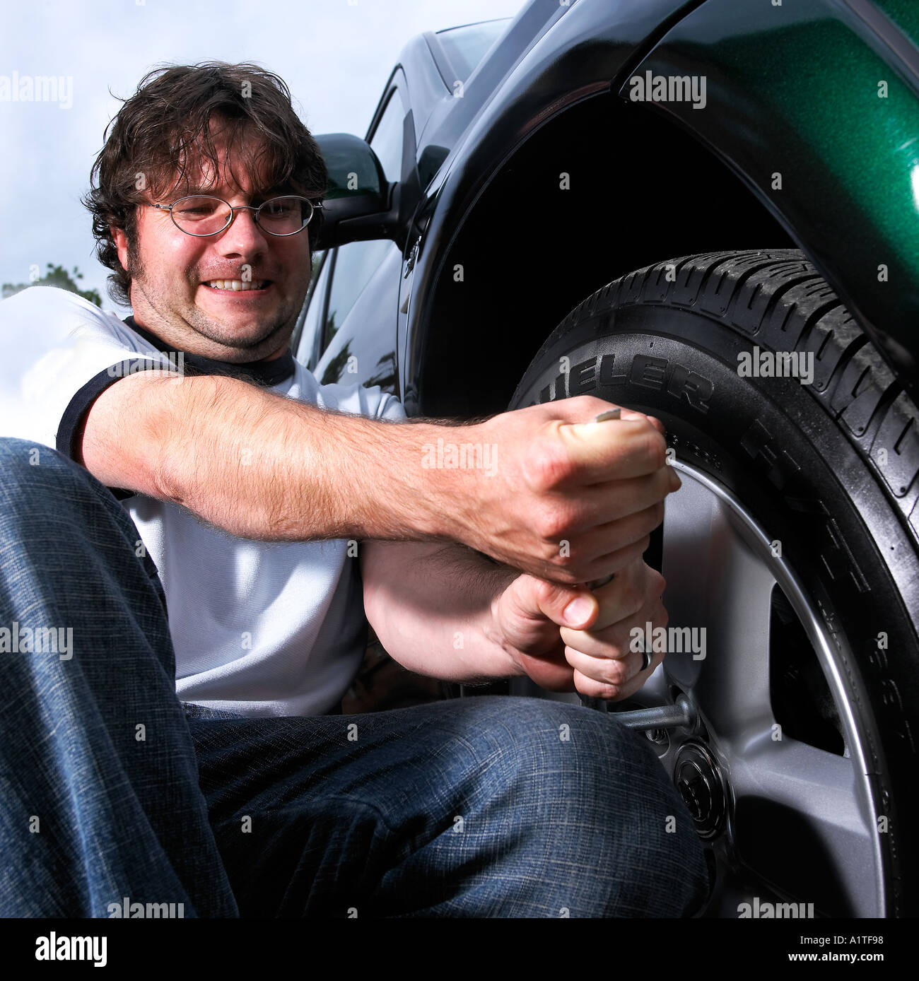Untightening wheel nuts with force Stock Photo - Alamy