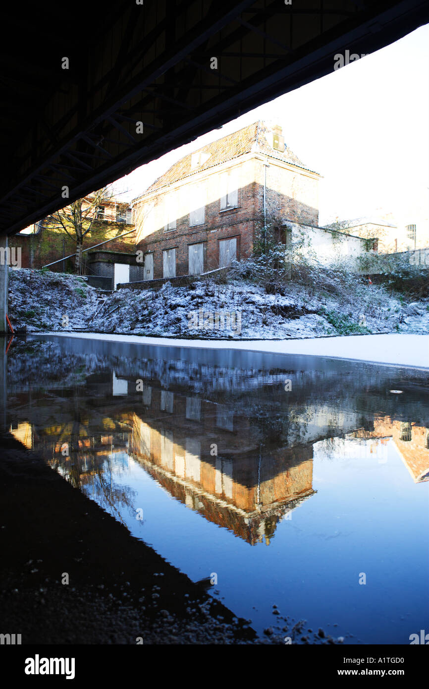 Old Warehouse and Derelict House with Large Puddle and Snow Stock Photo ...