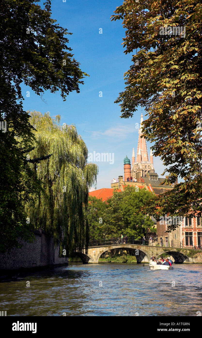 A canal scene with the cathedral in the lovely medieval city of Bruges ...
