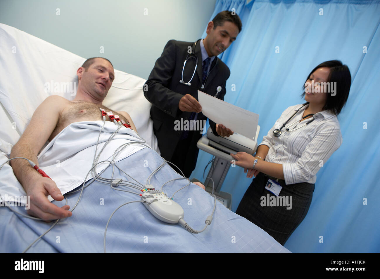Doctor reading ecg hi-res stock photography and images - Alamy
