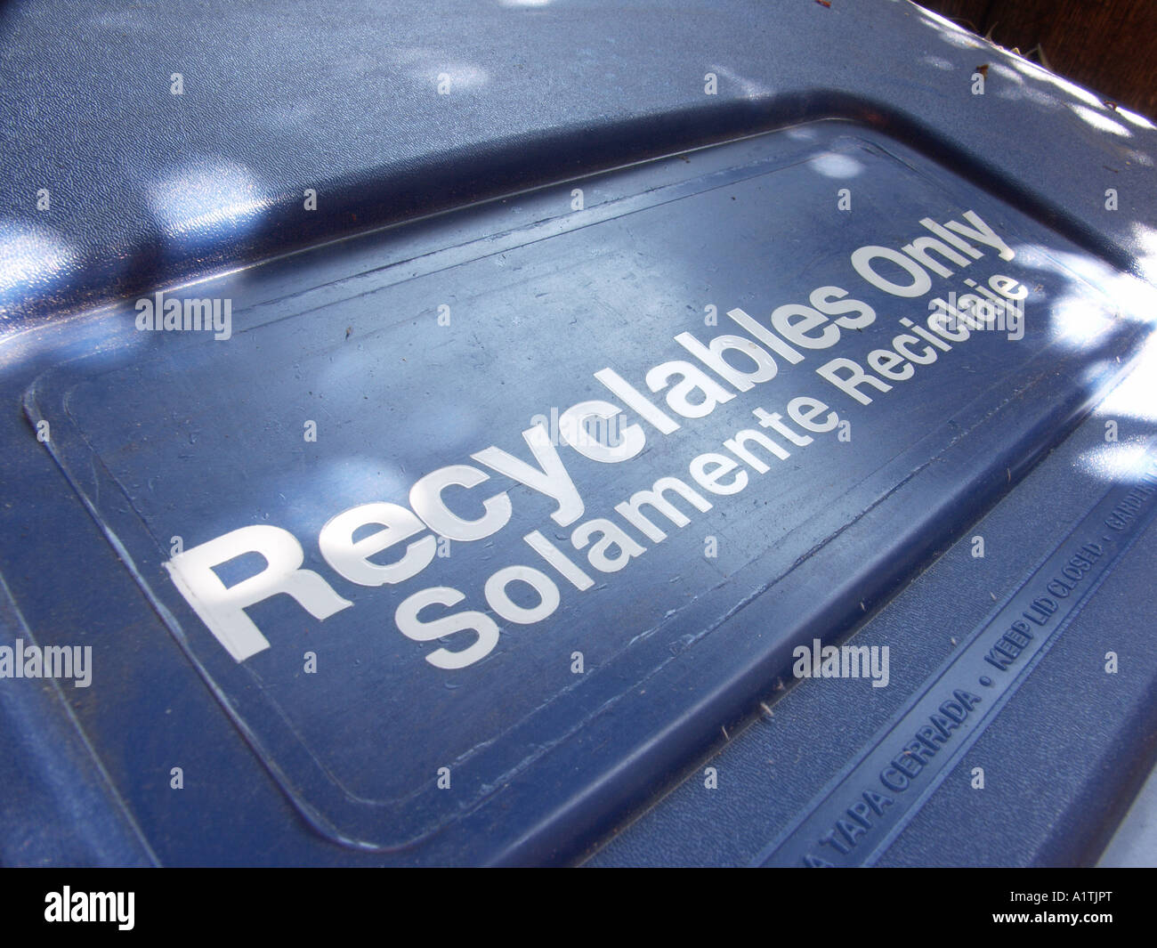 Container for recycling waste labeled in English and Spanish Stock ...