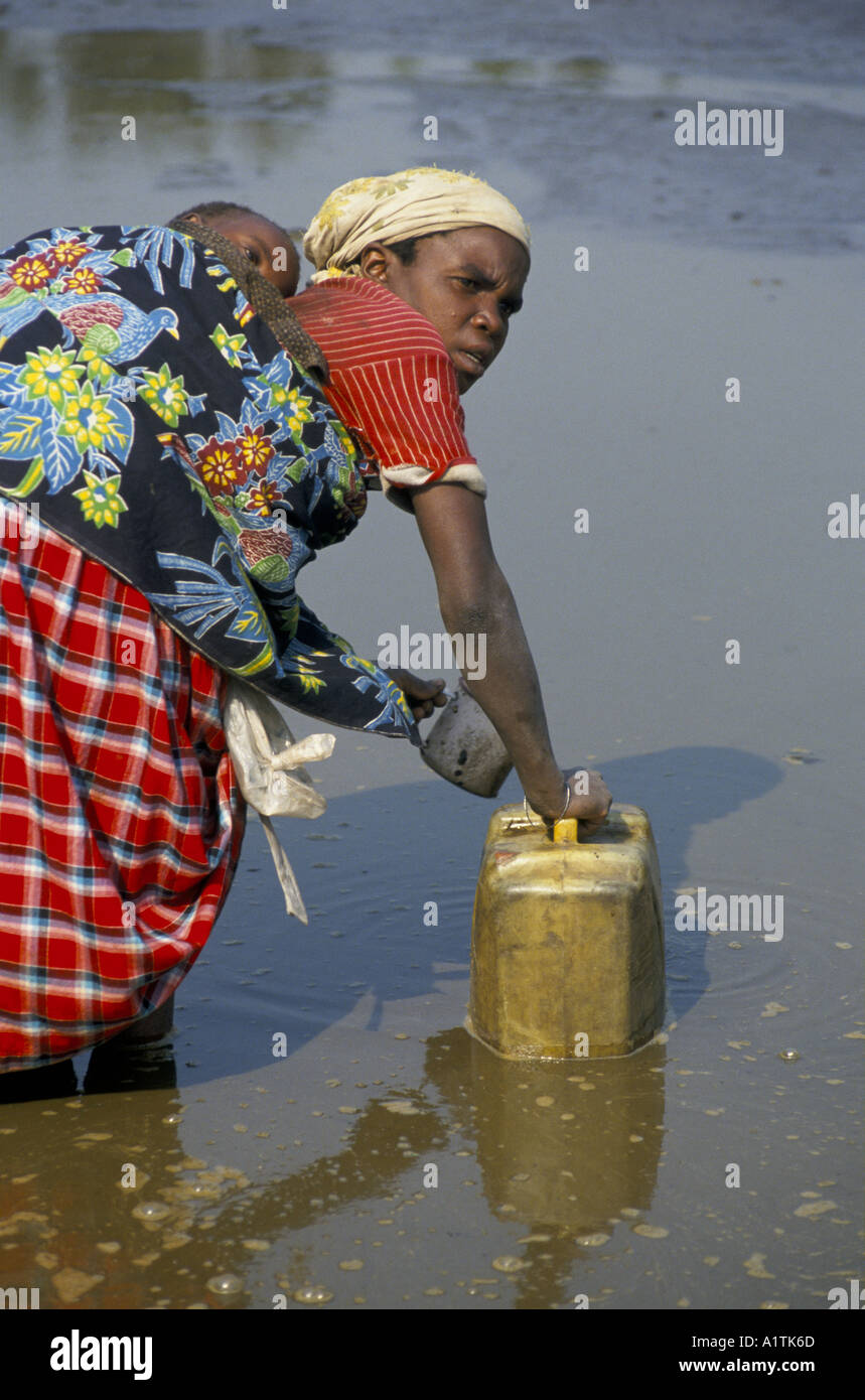 Goma, Zaire (Congo) Refugee camp, a woman with a baby on her back ...