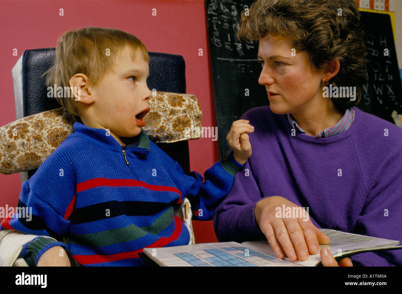 DISABLED CHILD TALKING USING BLISS SYMBOLS Stock Photo - Alamy