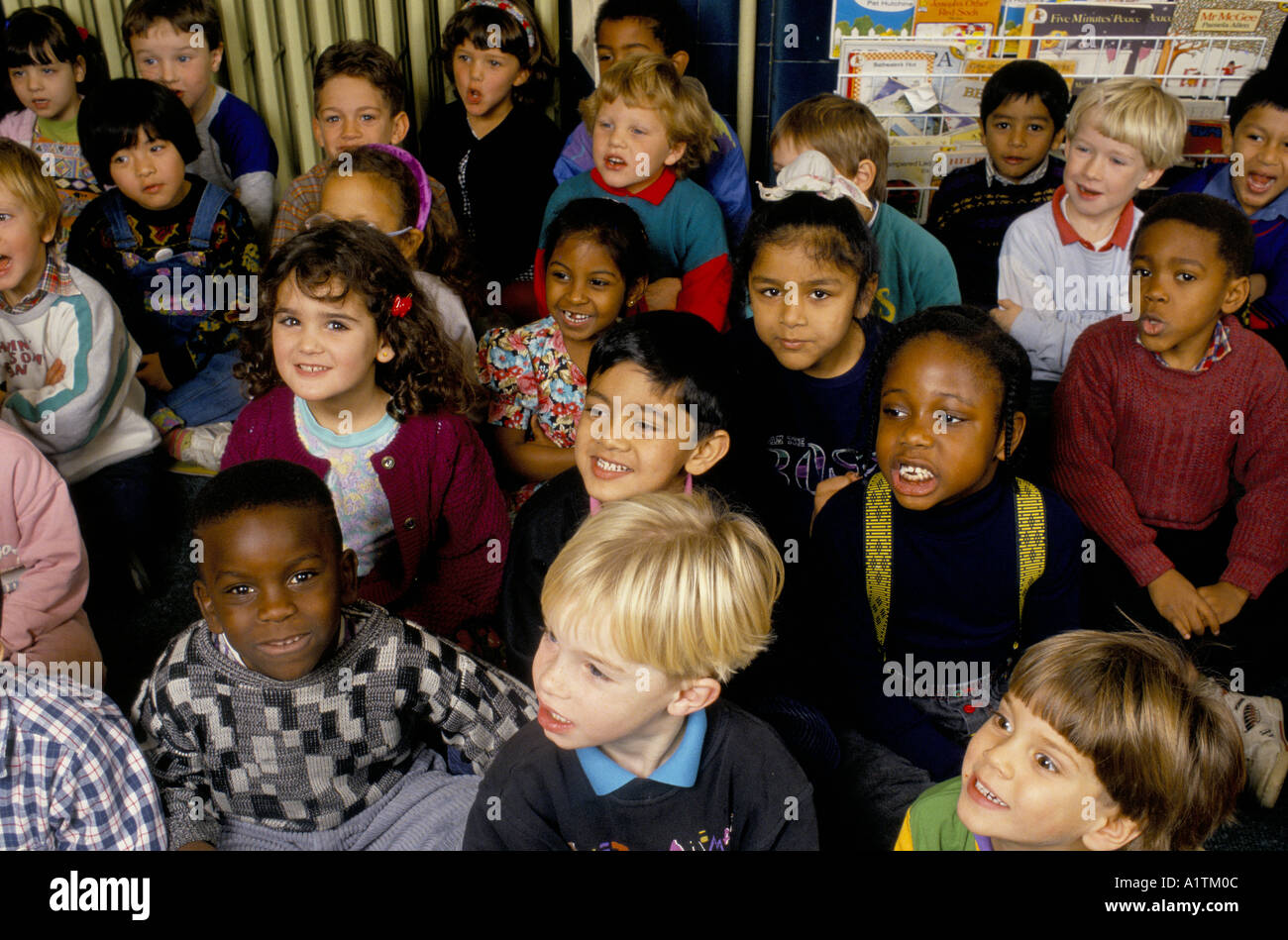 EDUCATION.Children in primary school sitting on the floor listening to ...