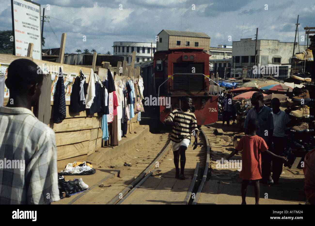Train running through Kumasi market in central Ghana Stock Photo - Alamy