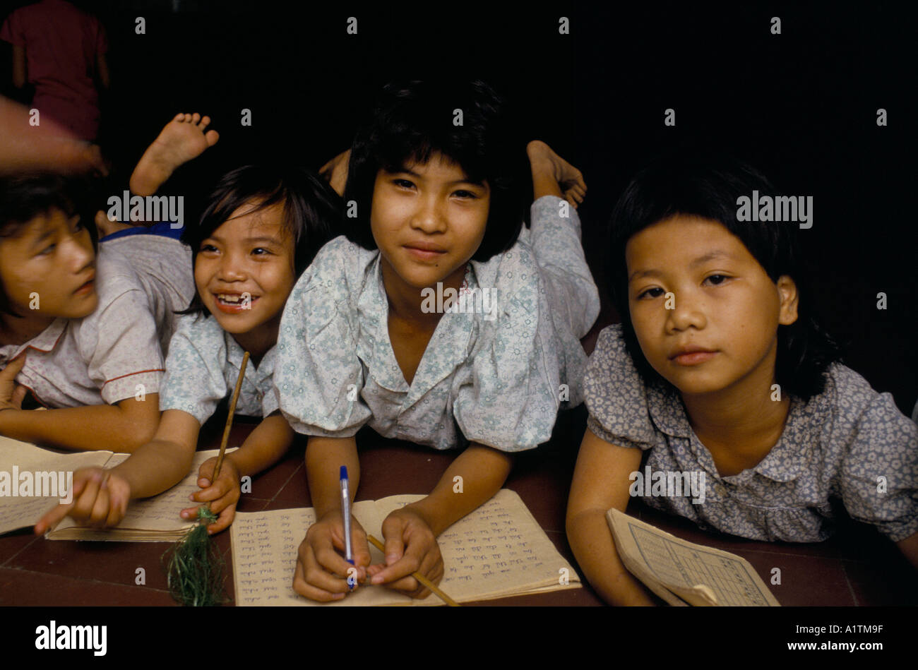 CHILDREN DOING HOMEWORK VIETNAM 1991 Stock Photo - Alamy