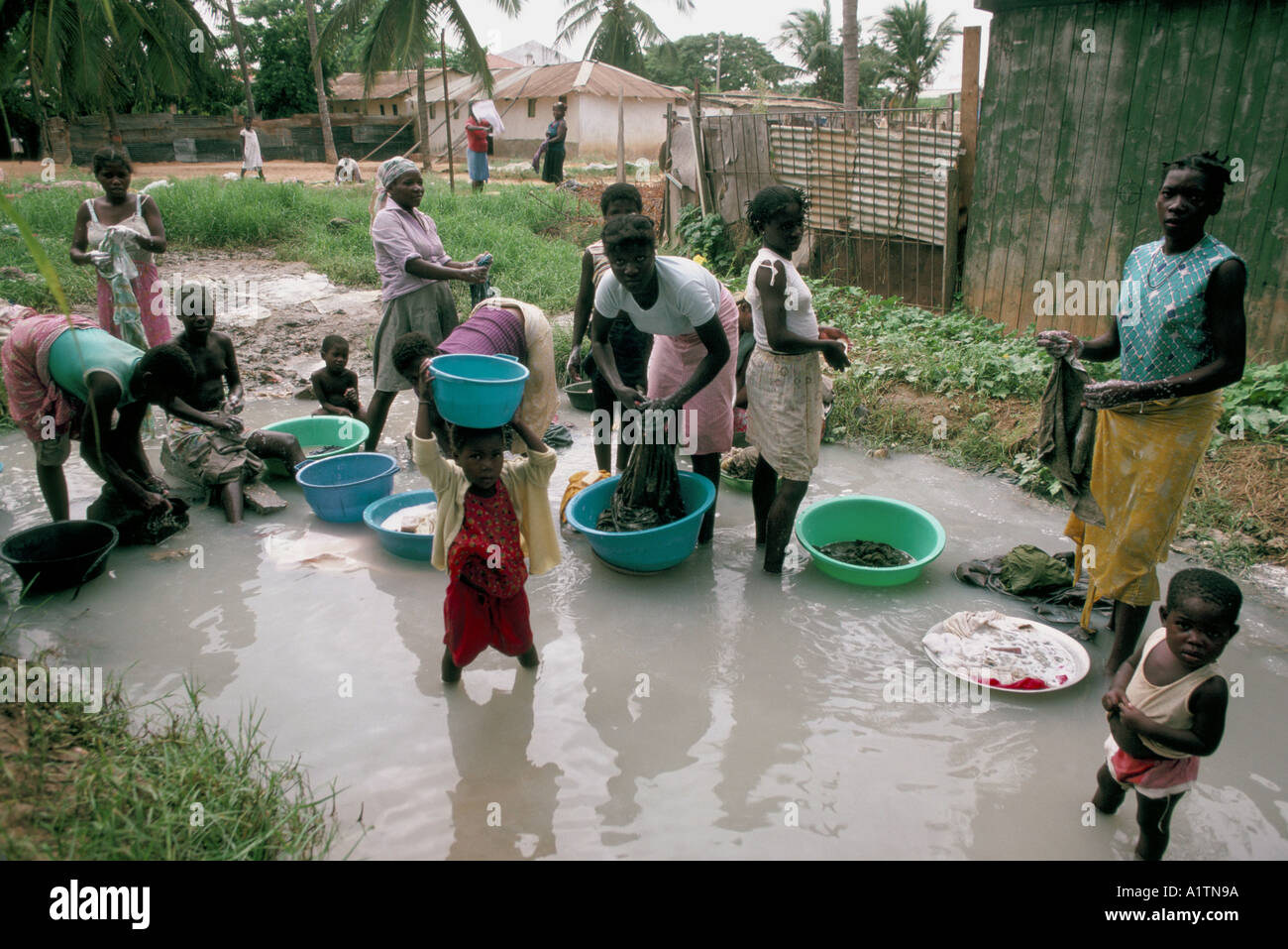ANGOLA LUANDA WOMEN AND CHILDREN WASHING CLOTHES WITH CHILD CARRYING ...
