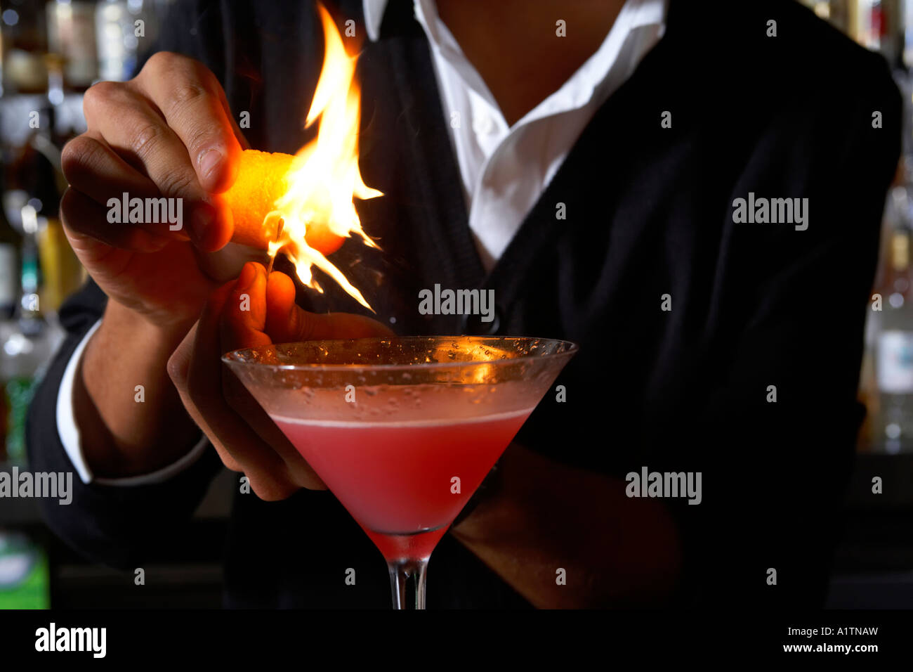 Cocktail barman flaming a cocktail Stock Photo - Alamy