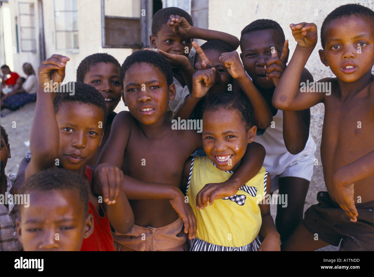 GROUP OF CHILDREN SMILING MAKING SIGNS AT MALMESBURY SQUATTERS CAMP ...