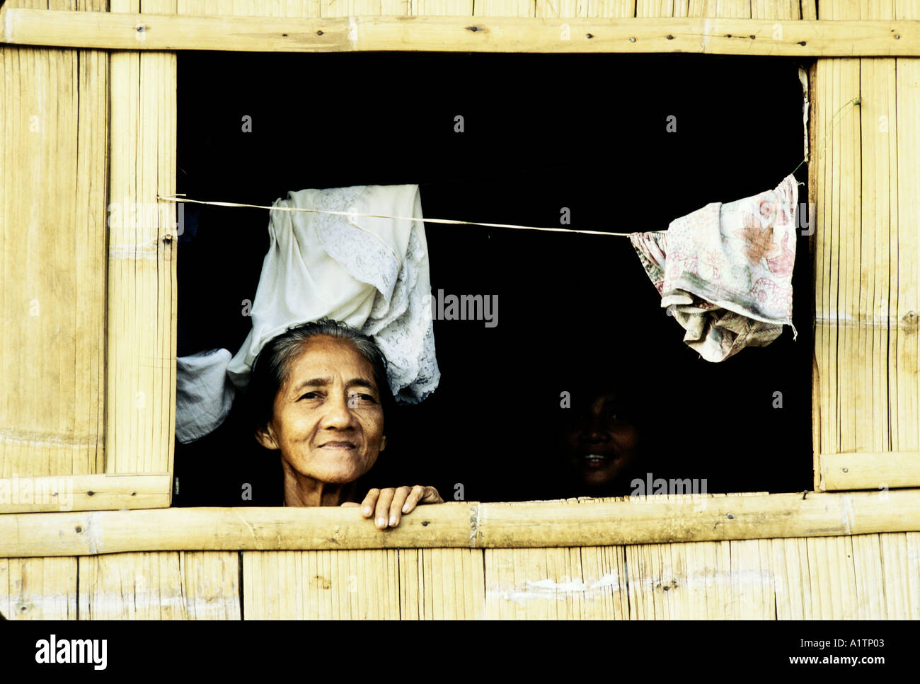 PHILLIPINO WOMAN IN WINDOW OF BAMBOO HUT HOME .MINDANAO Stock Photo - Alamy
