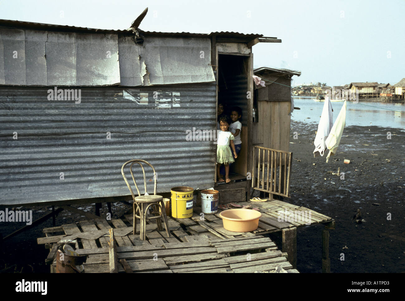 Two children in doorway of shack.POOR HOUSING MANILA PHILIPPINES 2 91 ...