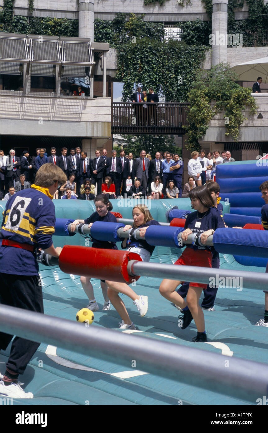 PEOPLE PLAYING HUMAN TABLE FOOTBALL IN THE CITY LONDON Stock Photo - Alamy