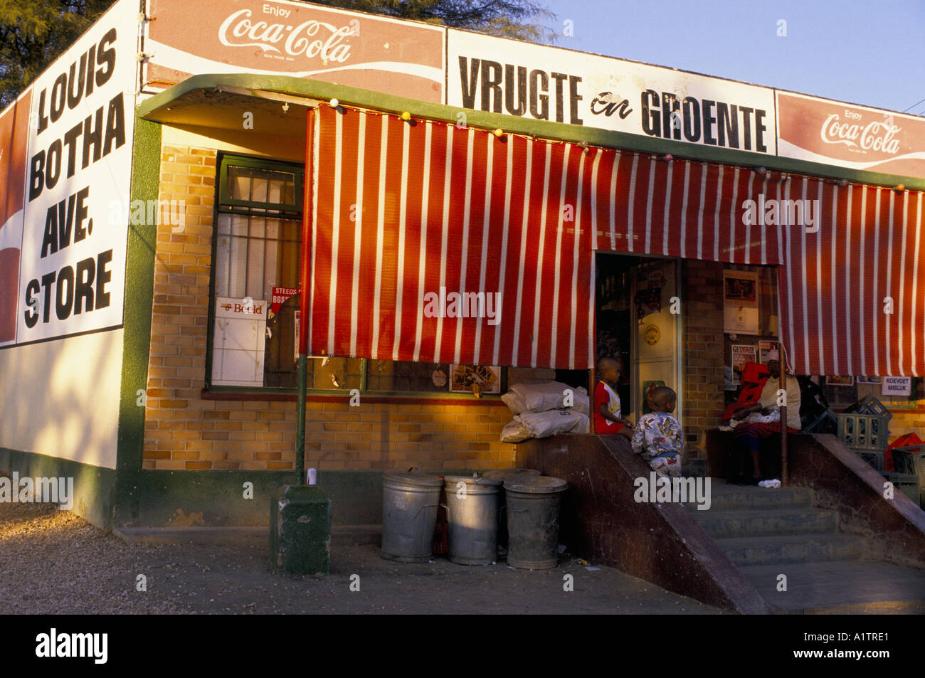 NAMIBIA WINDHOEK CORNER STORE . CHILDREN SITTING ON THE PORCH AT THE ...