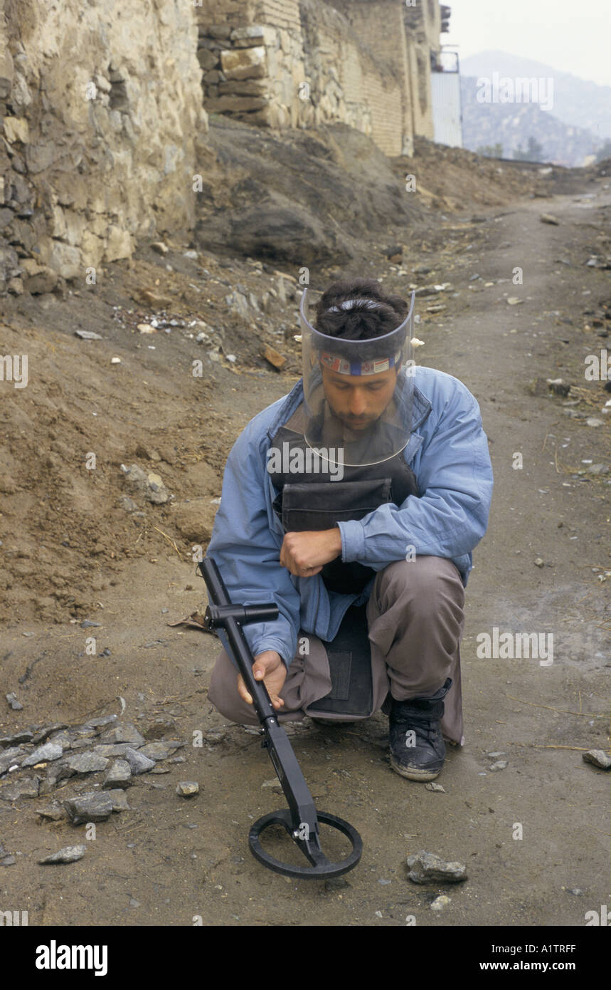 MINES IN AFGHANISTAN . DEMINING KABUL 1996. Deminer working in heavily ...