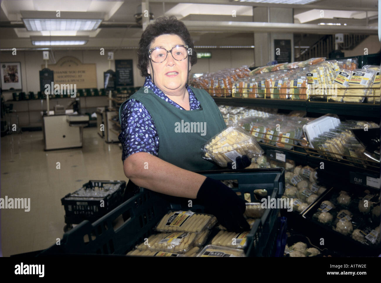 MARKS SPENCERS EMPLOYEE ARRANGING MINI SWEET CORN 1994 Stock Photo - Alamy