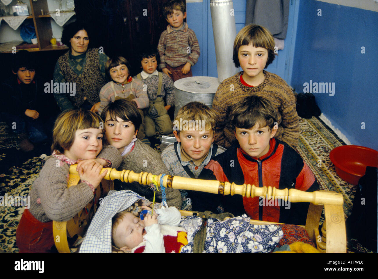 POOR ALBANIAN FAMILY WITH LARGE GROUP OF CHILDREN AROUND BABY IN A ...