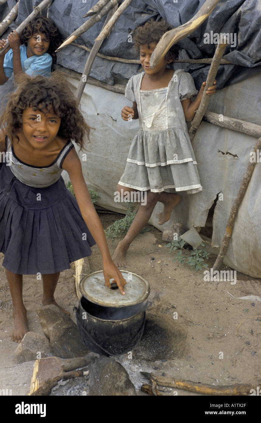 LAND INVASION.Young girl with a cooking pot on an open fire. She lives ...
