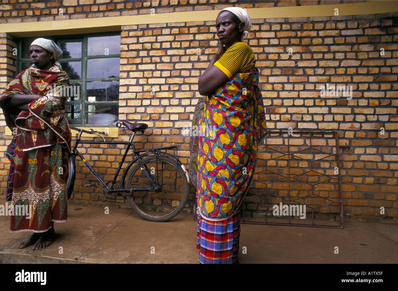 WOMEN IN RWANDA STANDING OUTSIDE WITH BICYCLE WEARING TRADITIONAL ...