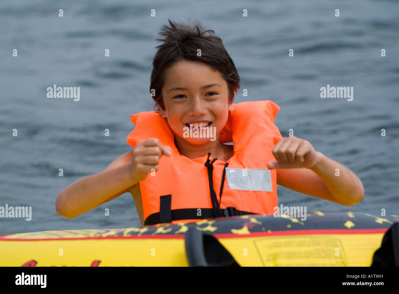 Boy sitting on an inflatable raft Biscarrosse lake in France Stock ...