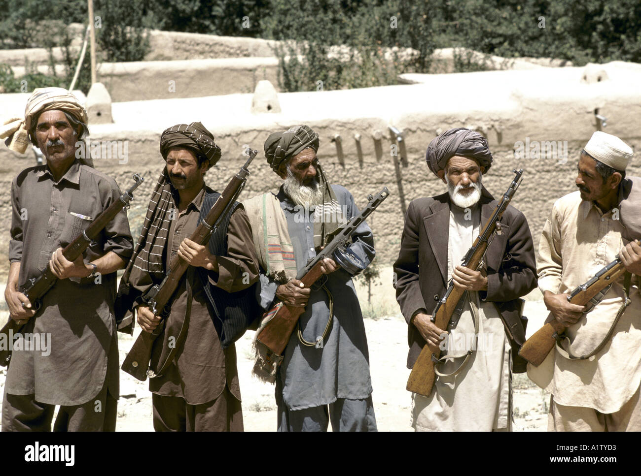 Line of local village militia with guns Stock Photo - Alamy