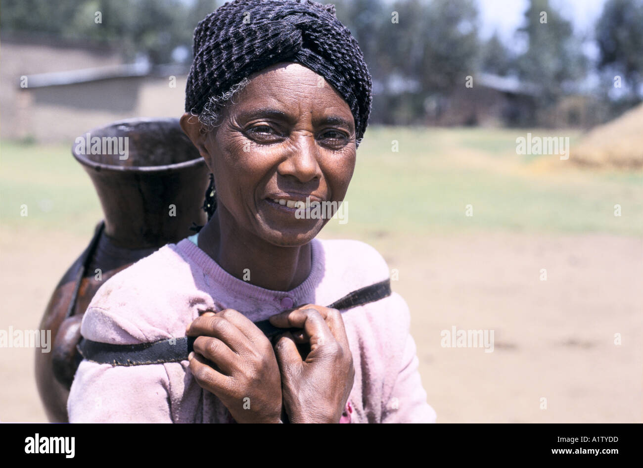WOMAN COLLECTING WATER , WITH CLAY POT TIED ON HER BACK1994 Stock Photo ...