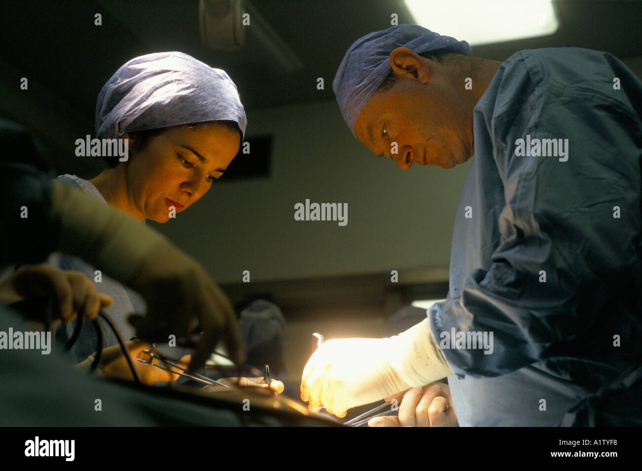 SURGEON AND DOCTOR SEWING UP AFTER OPERATION HARLEY STREET Stock Photo ...