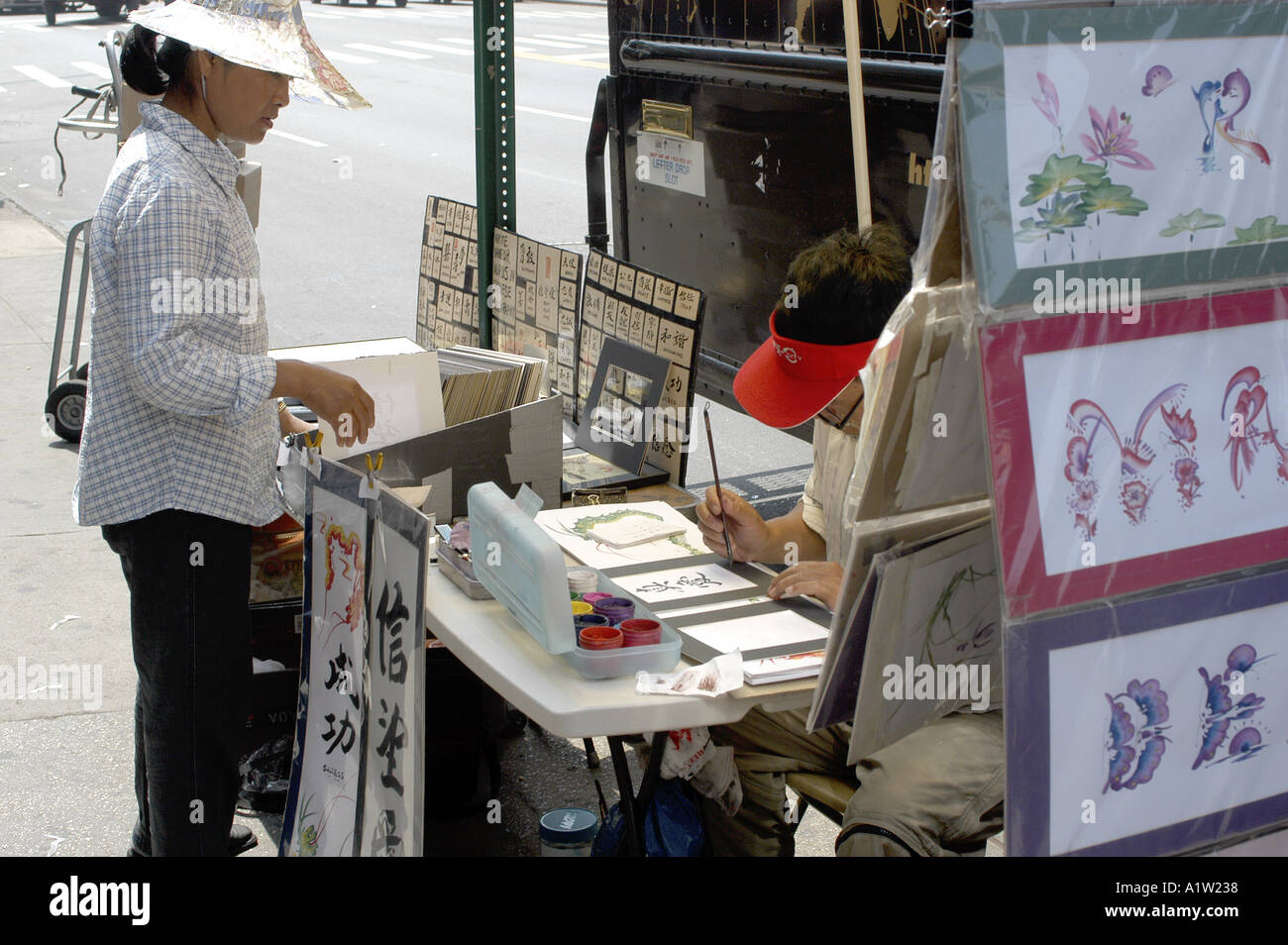 Street chinese calligraphy artist writting with black ink and chinese ...