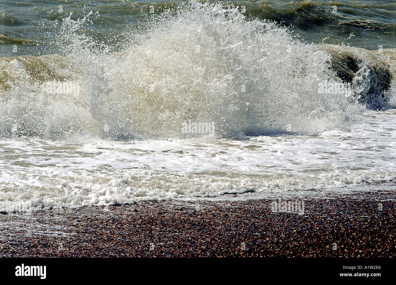 Wave breaking shingle Splash surf large wave crashing onto the beach ...