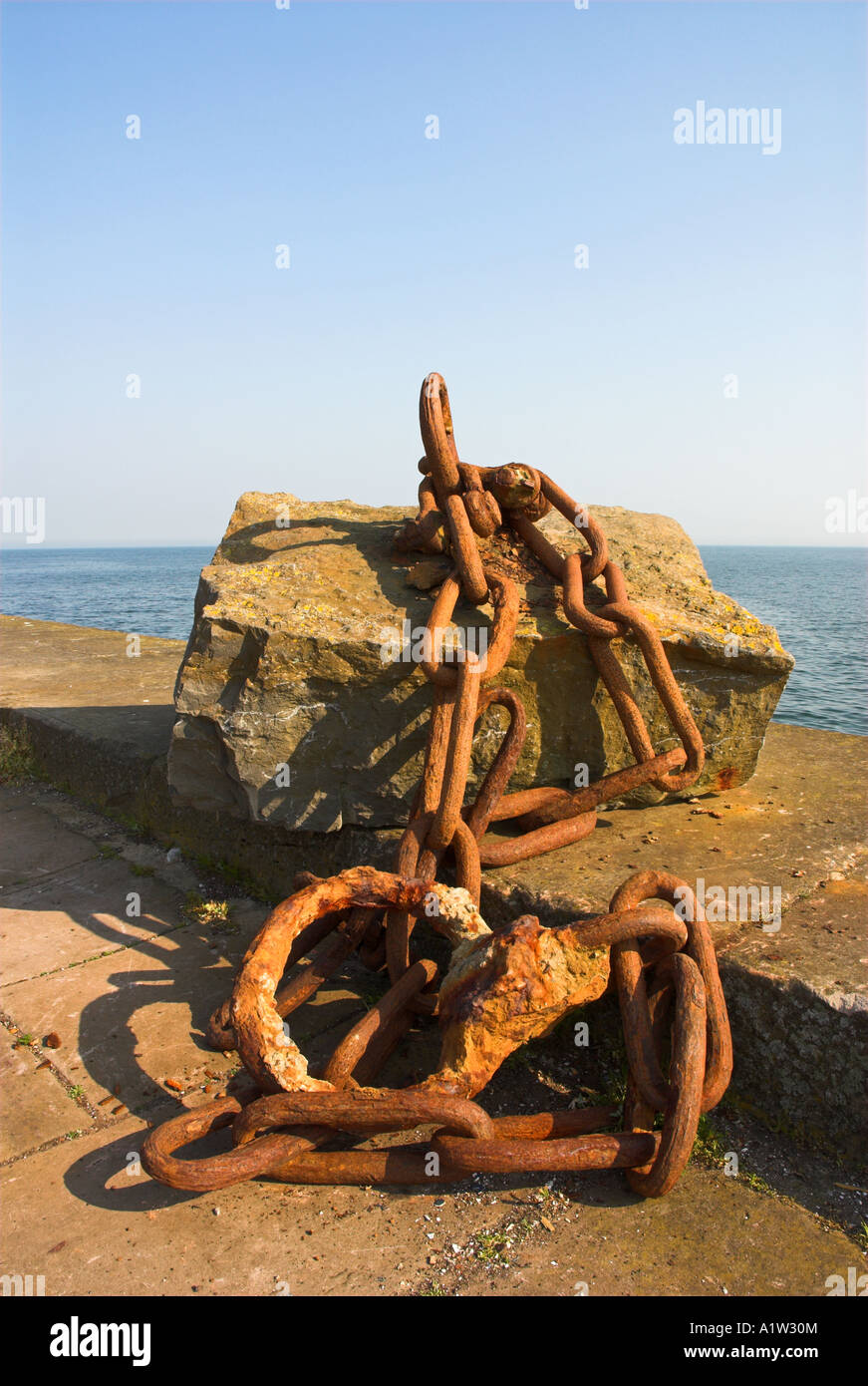 rusty chain old with big rock Stock Photo - Alamy