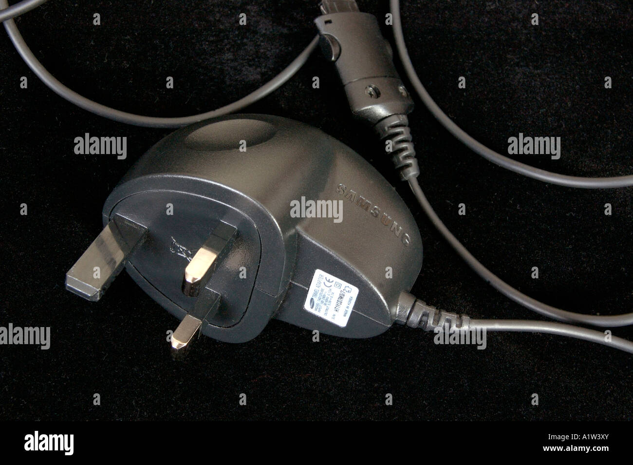 A mobile phone charger fitted with three pin british safety plug Stock ...