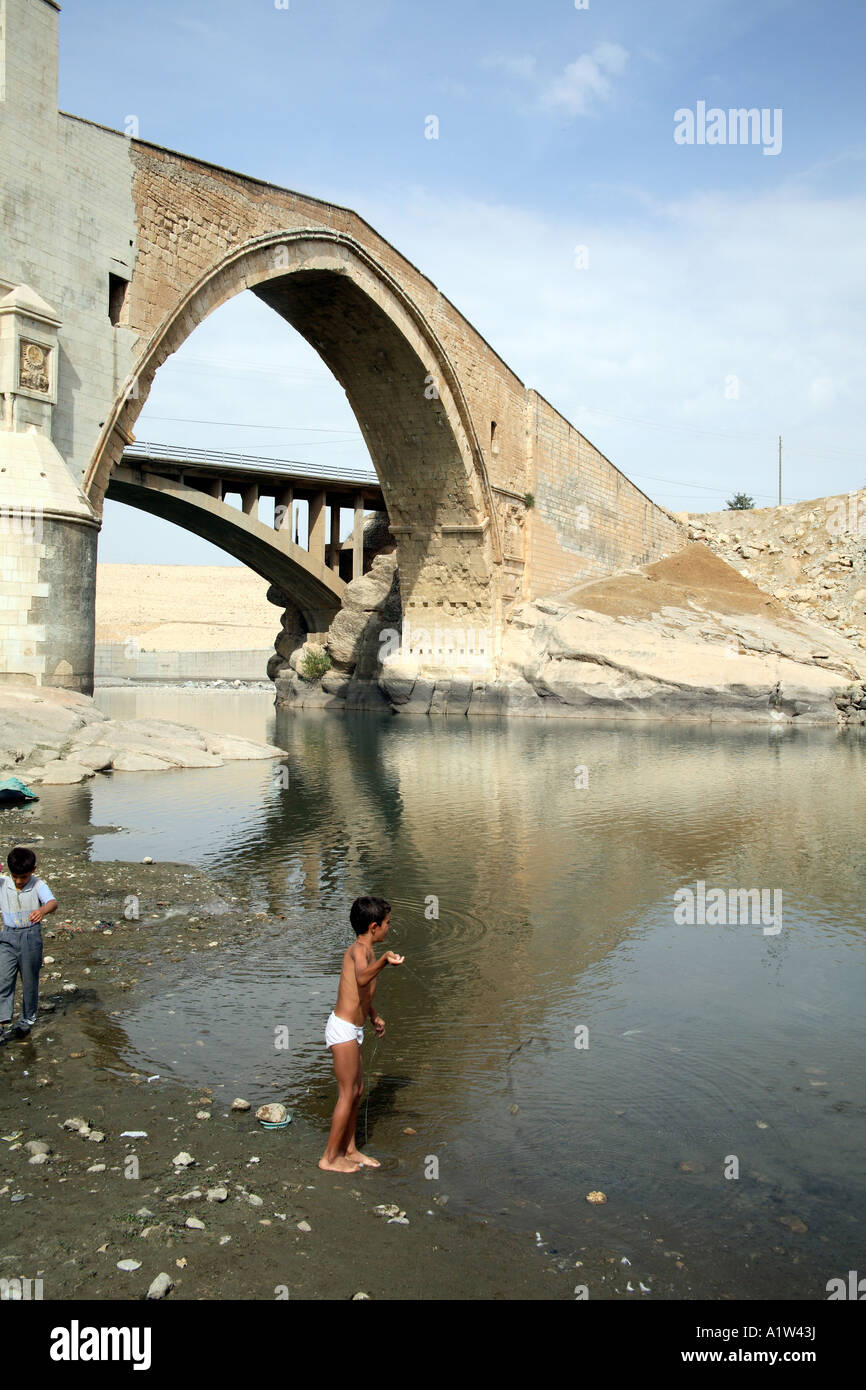 Kurdish boy fishing by Catakkopru bridge. Eastern Turkey Stock Photo ...