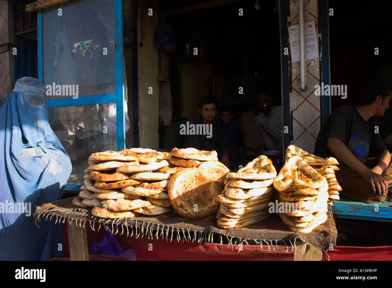 AFGHANISTAN Central Kabul Shor Bazaar Lady buying bread from bakery ...